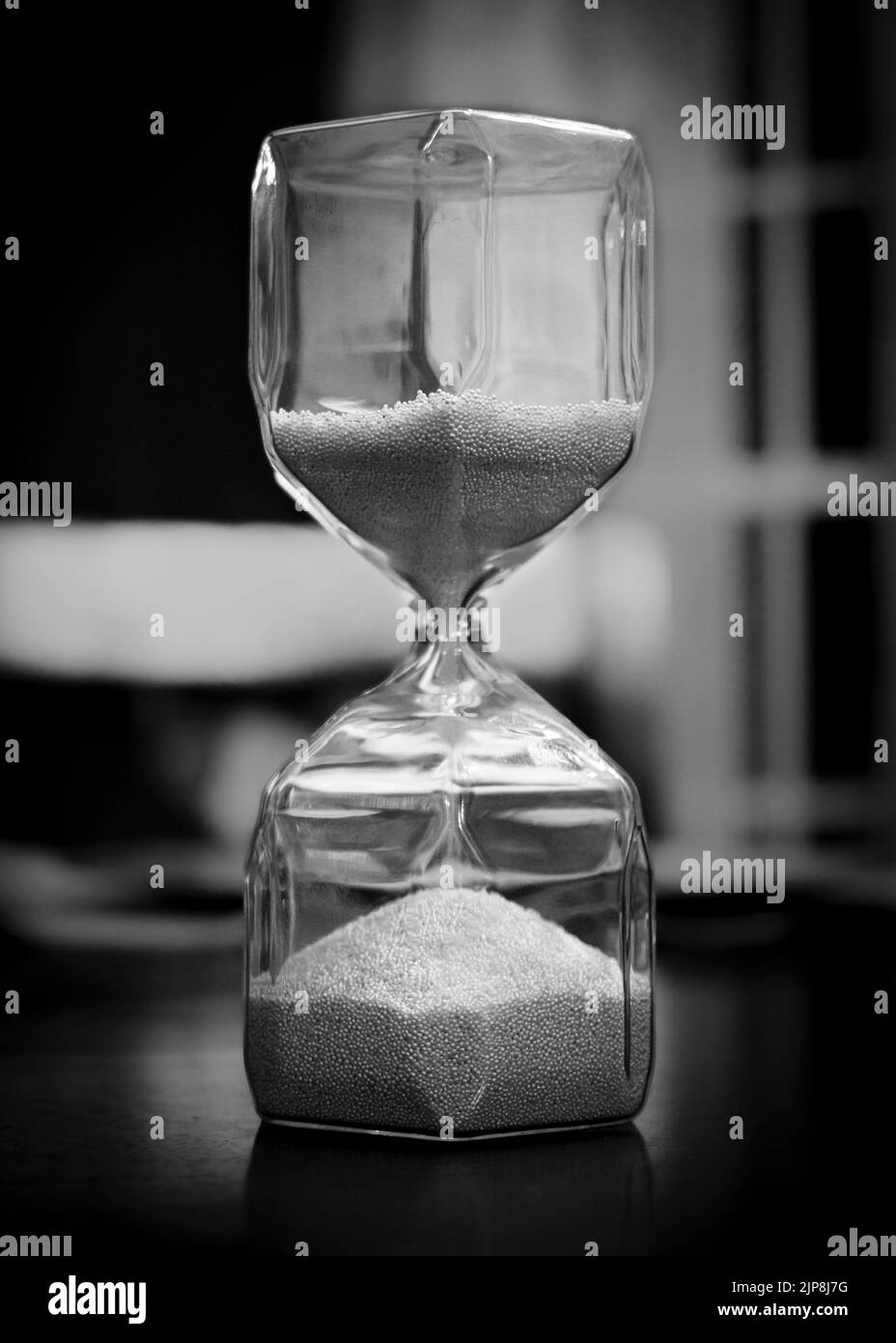 A grayscale shot of an hourglass Stock Photo - Alamy