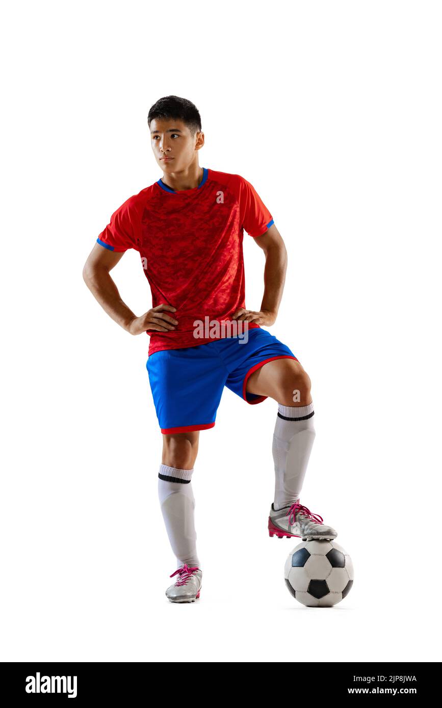 Portrait of proud young man, football player in uniform posing with ...