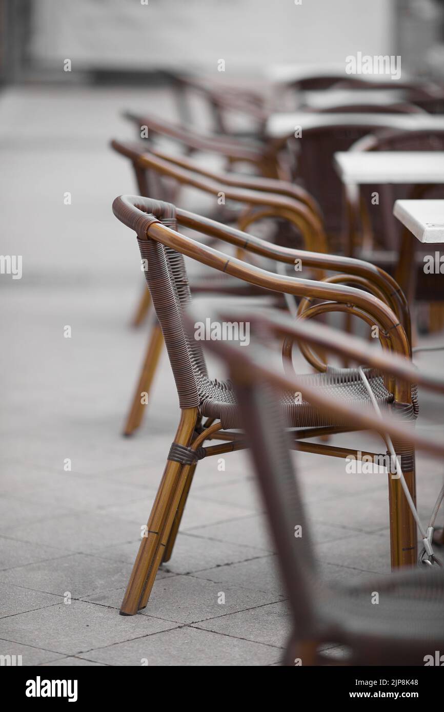The empty wooden chairs with tables in an outdoor cafe Stock Photo - Alamy