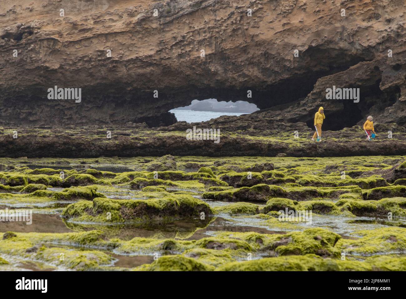 A beautiful view of two people walking through geological formations on ...