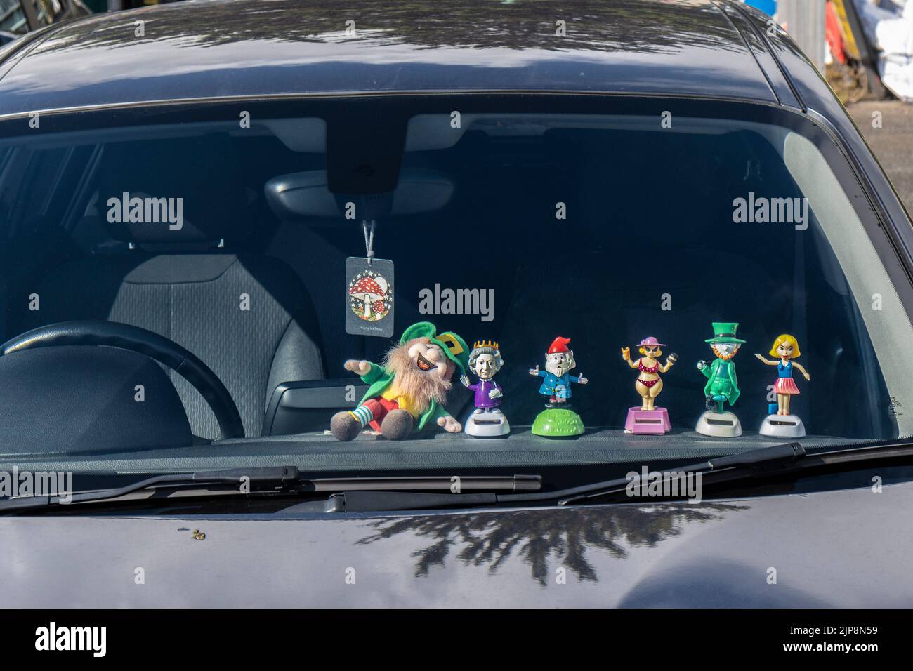 A collection of colourful; solar powered novelty plastic figures on the ...