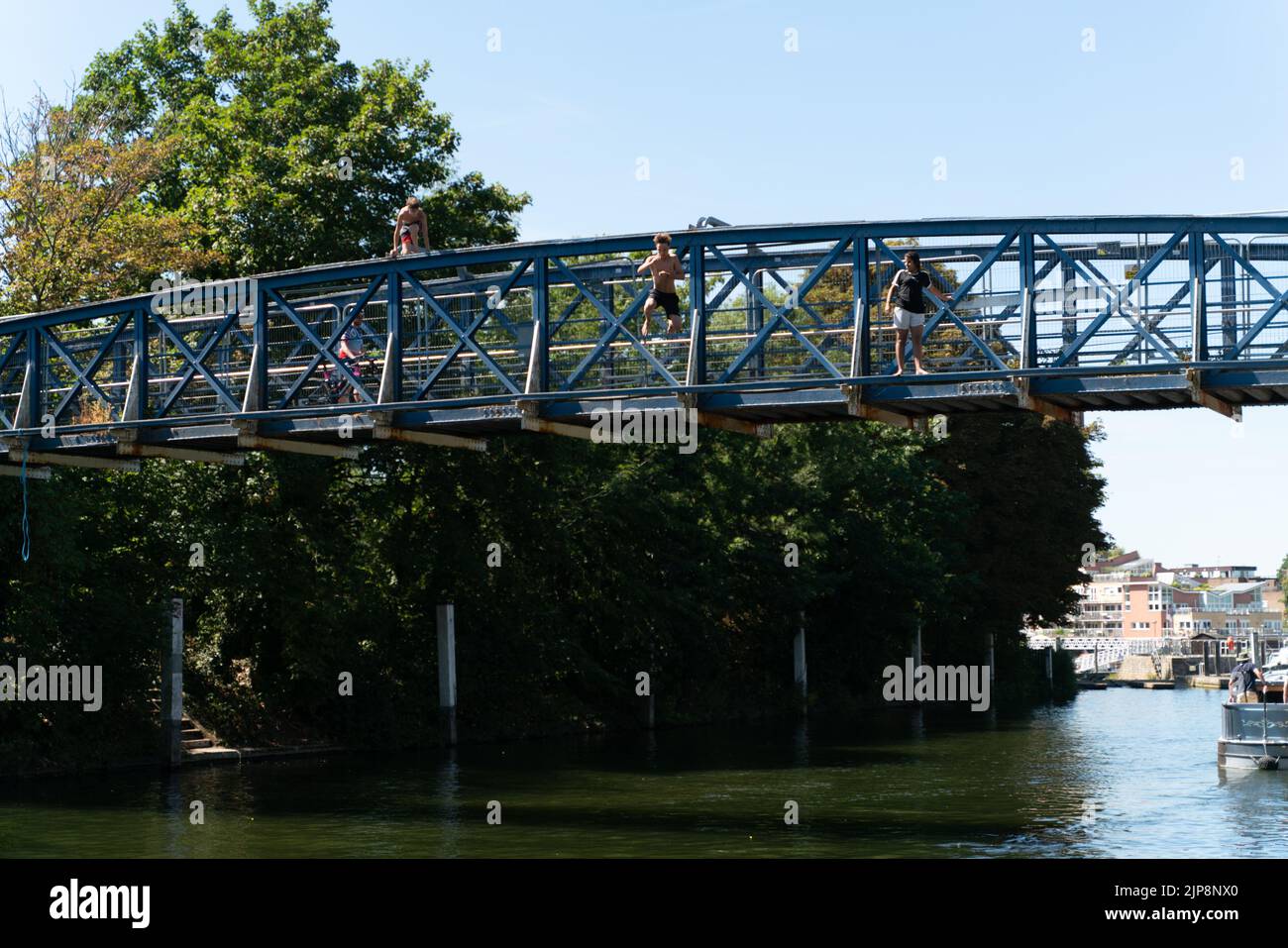 Boy Jumping From Bridge Stock Photo - Alamy