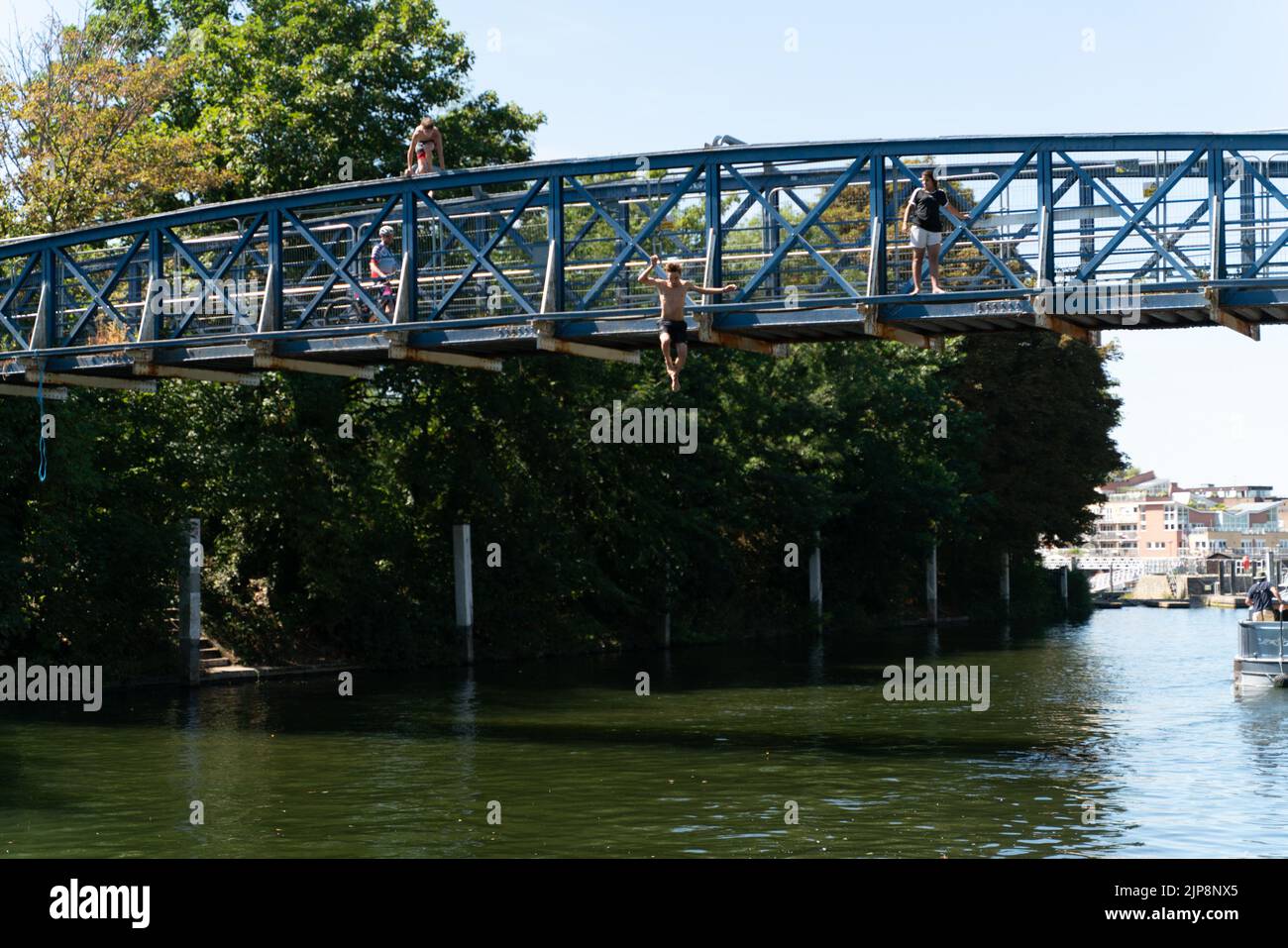 Boy Jumping From Bridge Stock Photo - Alamy