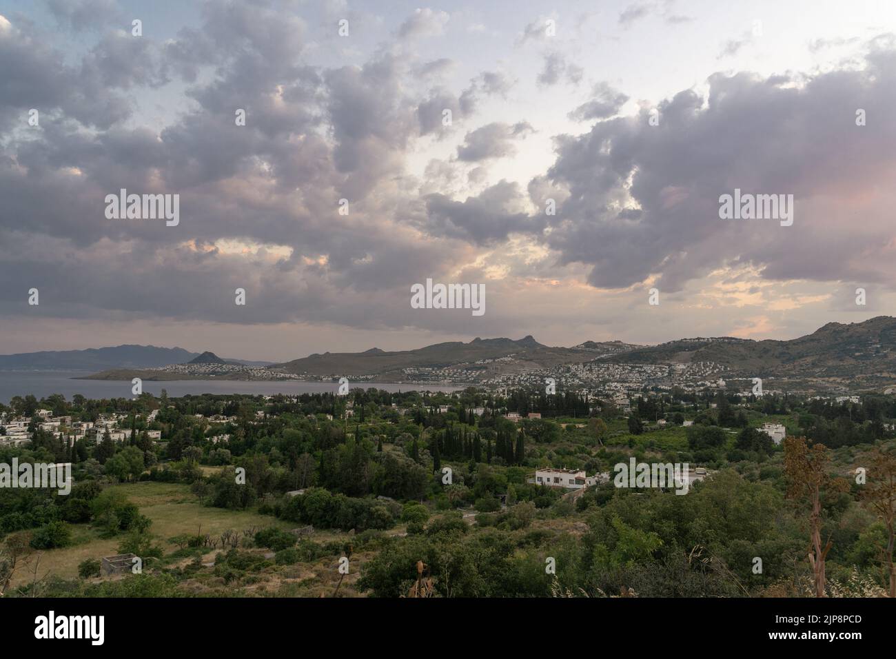 Sunset landscape at Bodrum, Turkey with green trees and sea at cloudy ...