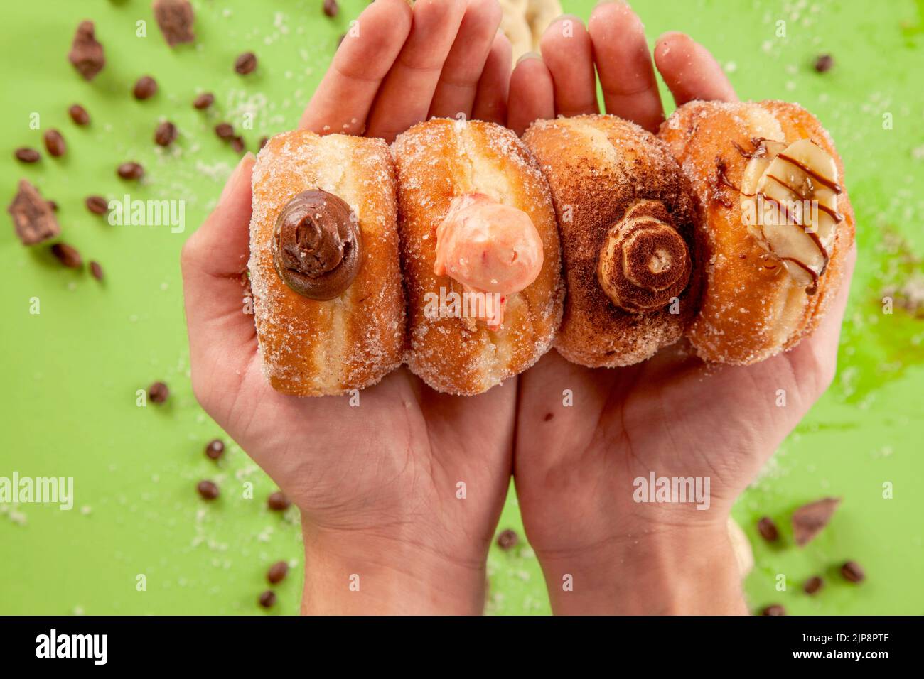 Hand holding doughnuts hi-res stock photography and images - Alamy