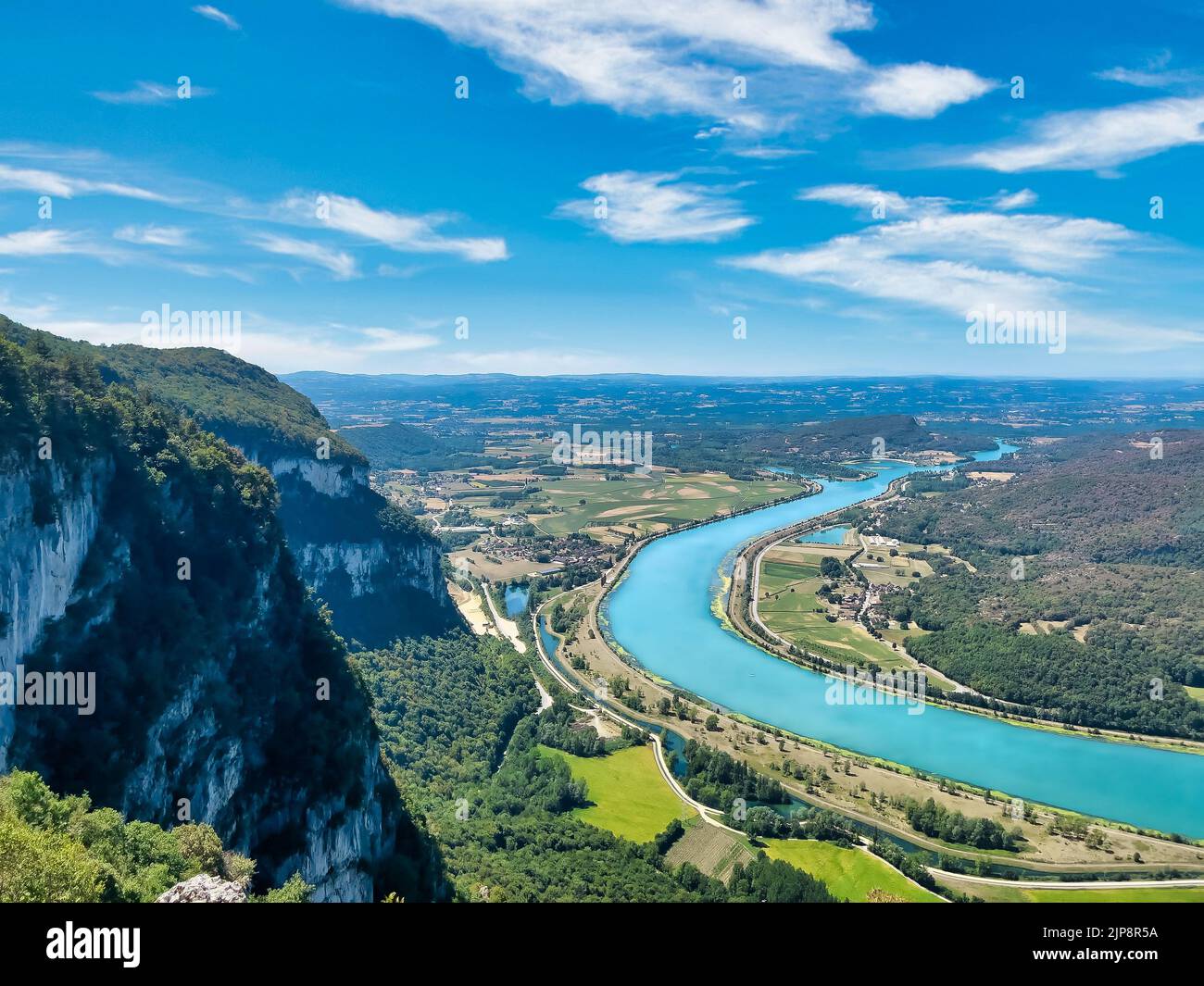 A bird's eye view of a river flowing through cultivated fields against ...