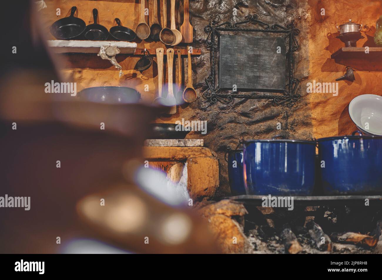 Cast iron pot with fresh herbs, spices and kitchen utensils for tasty ...