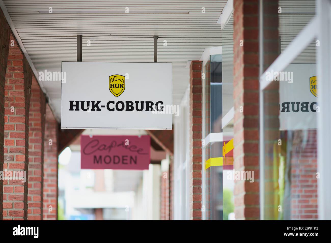 A german insurance company sign saying HUK-COBURG hanging from the ...