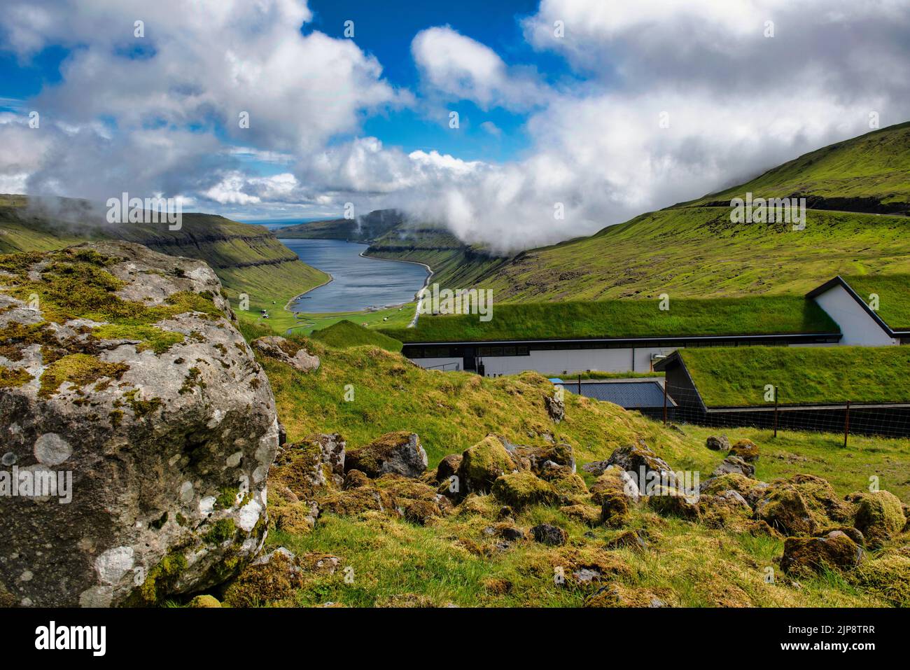 A bird's eye view of a fishing community and a prison with grass roofs ...