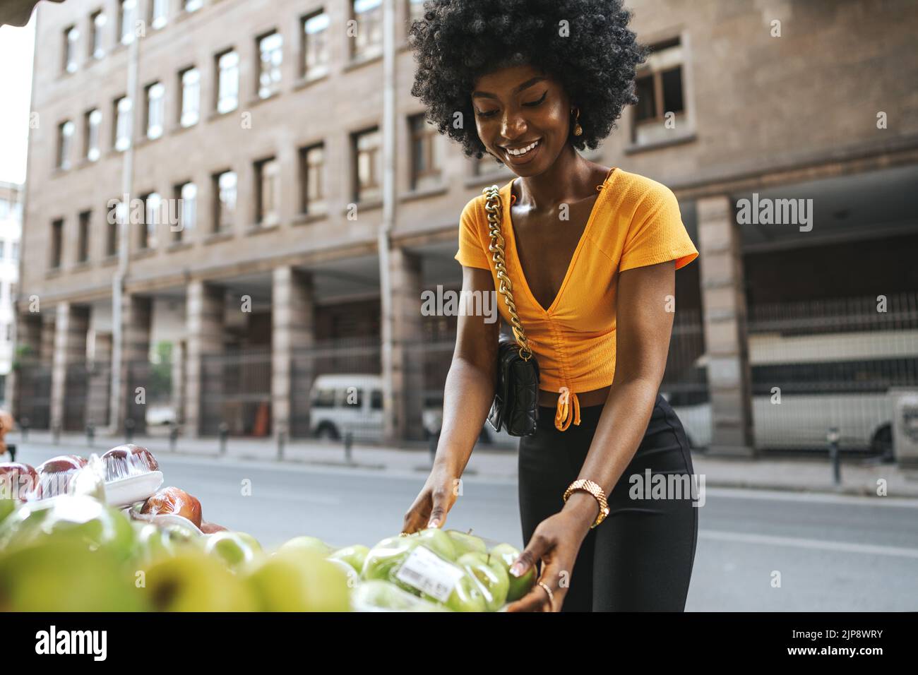 Young African American woman shopping at a local street market Stock ...