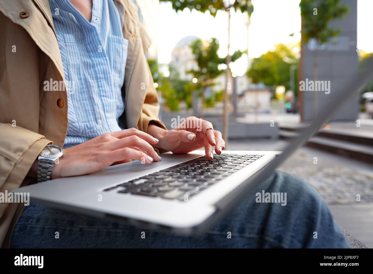 Close up of female hands typing on computer keyboard of a laptop ...