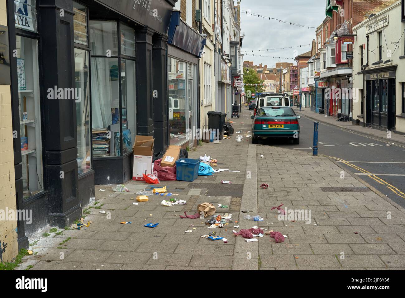 A dirty view of a street in Ramsgate filled with tons of litter with ...