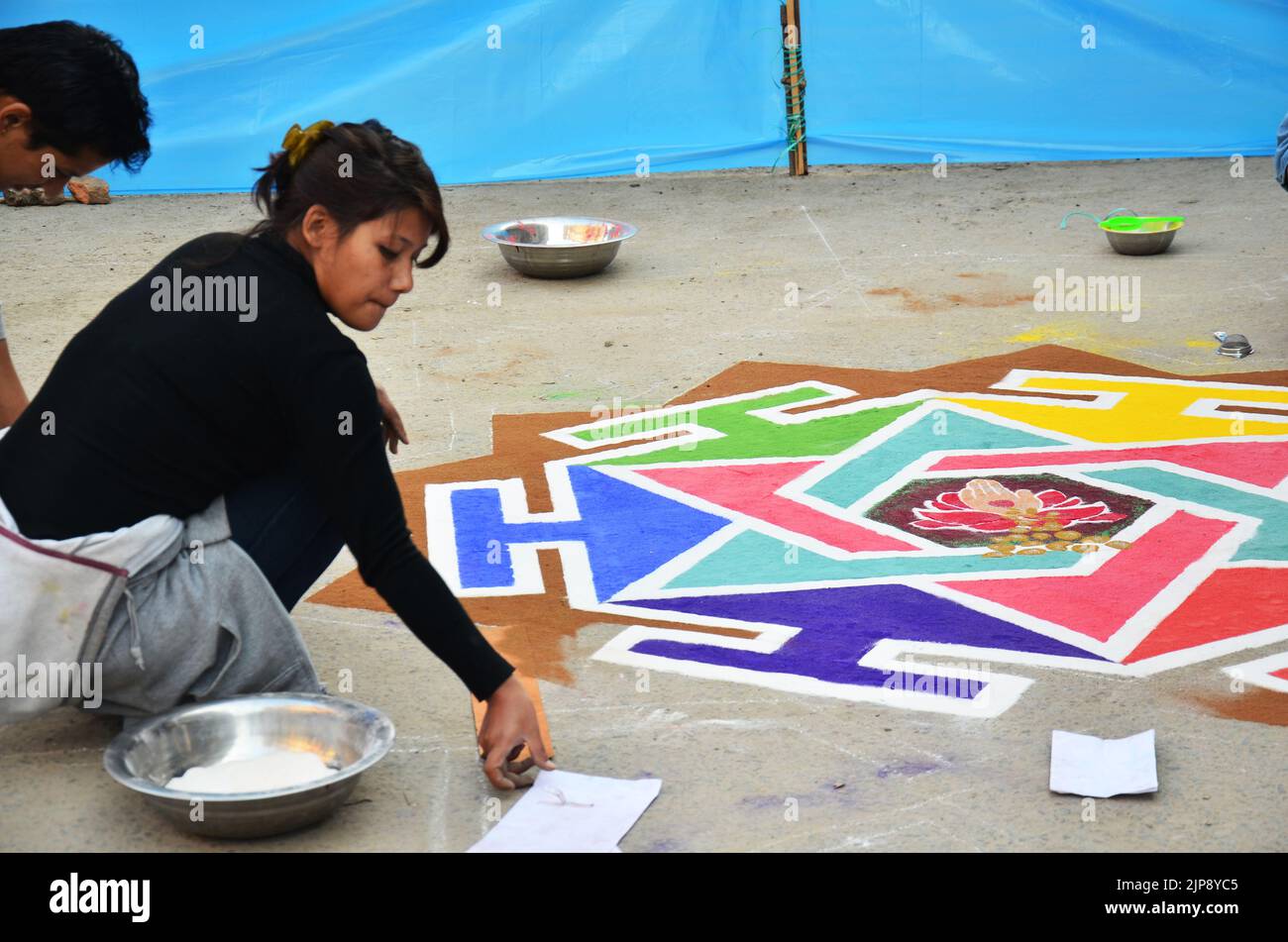 Nepalese drawing made rangoli symbol from powder or sand paint color ...