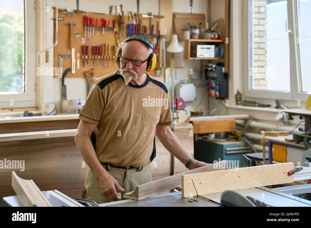 Male Caucasian carpenter taking measurements in his workshop Stock ...