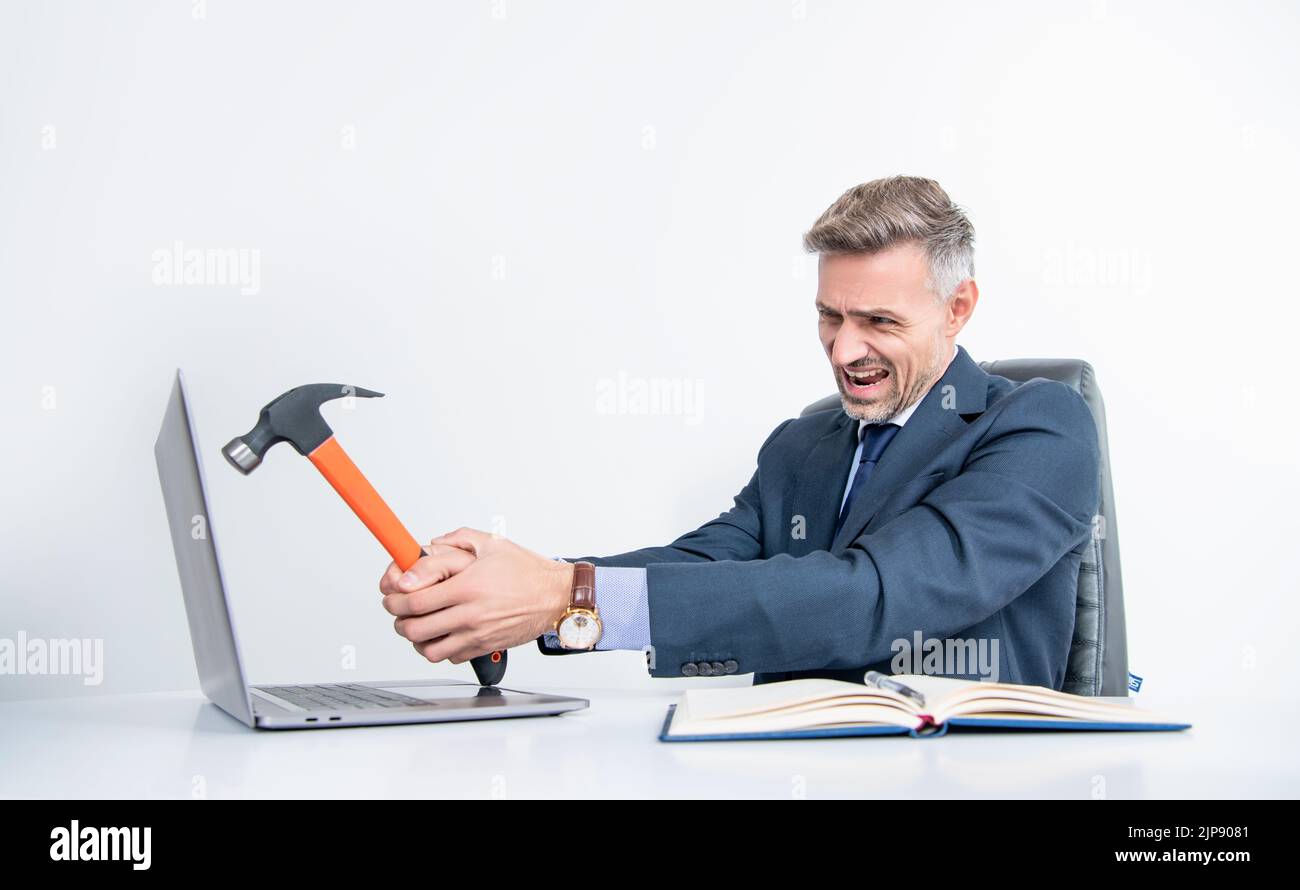 overworked boss hitting laptop with hammer in office Stock Photo - Alamy