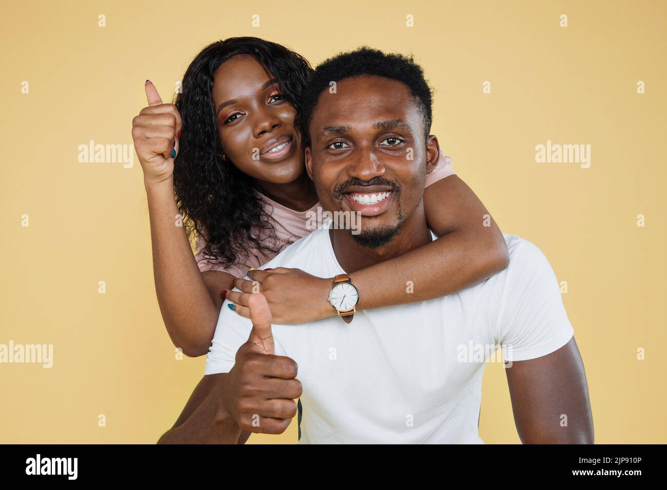 African female hugging with her arms back of boyfriend. Woman dressed ...