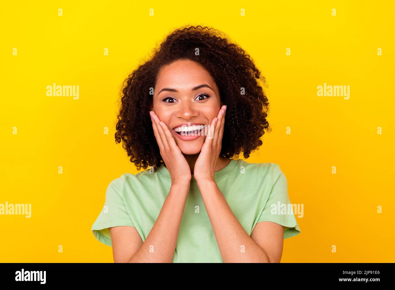 Photo of hooray brunette young lady hands face wear green t-shirt ...