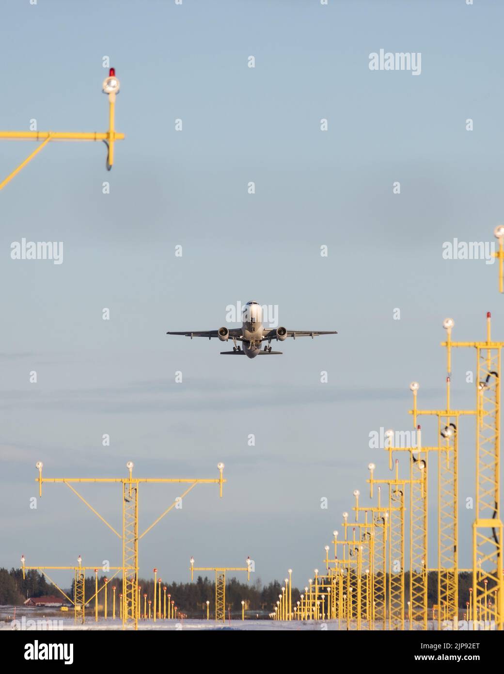 A vertical shot of an airplane taking off from the runway during the ...