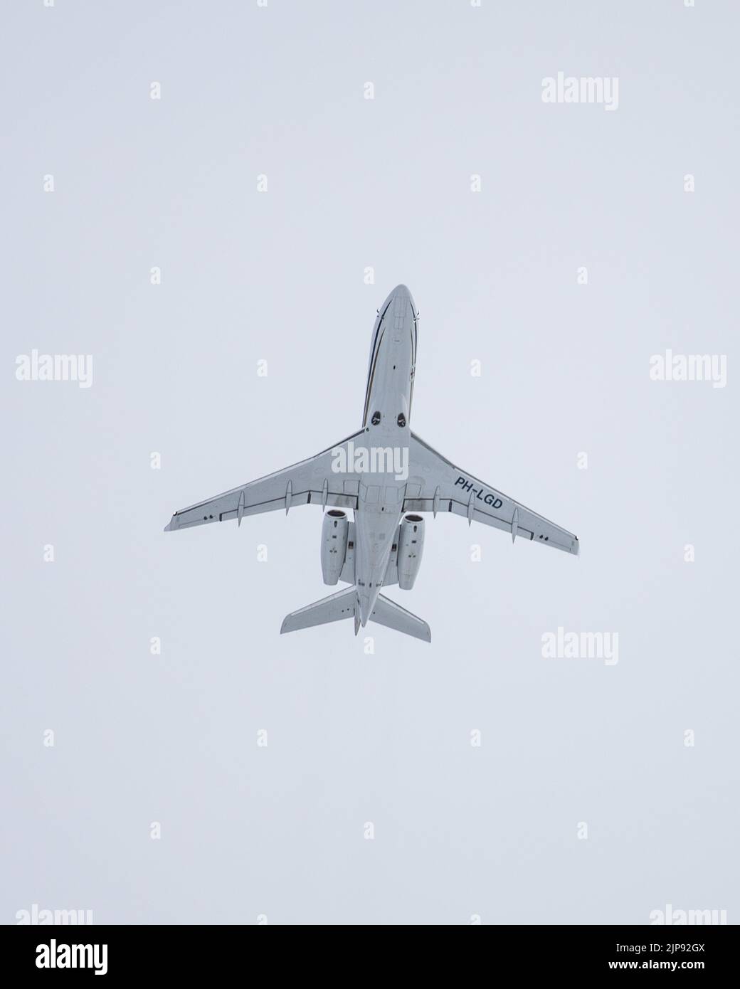 A vertical shot of an airplane taking off with the blue clear sky in ...