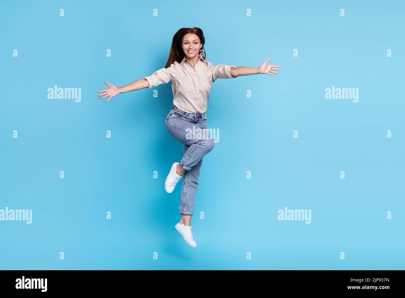 Full body photo of optimistic millennial lady jump hug wear shirt jeans ...