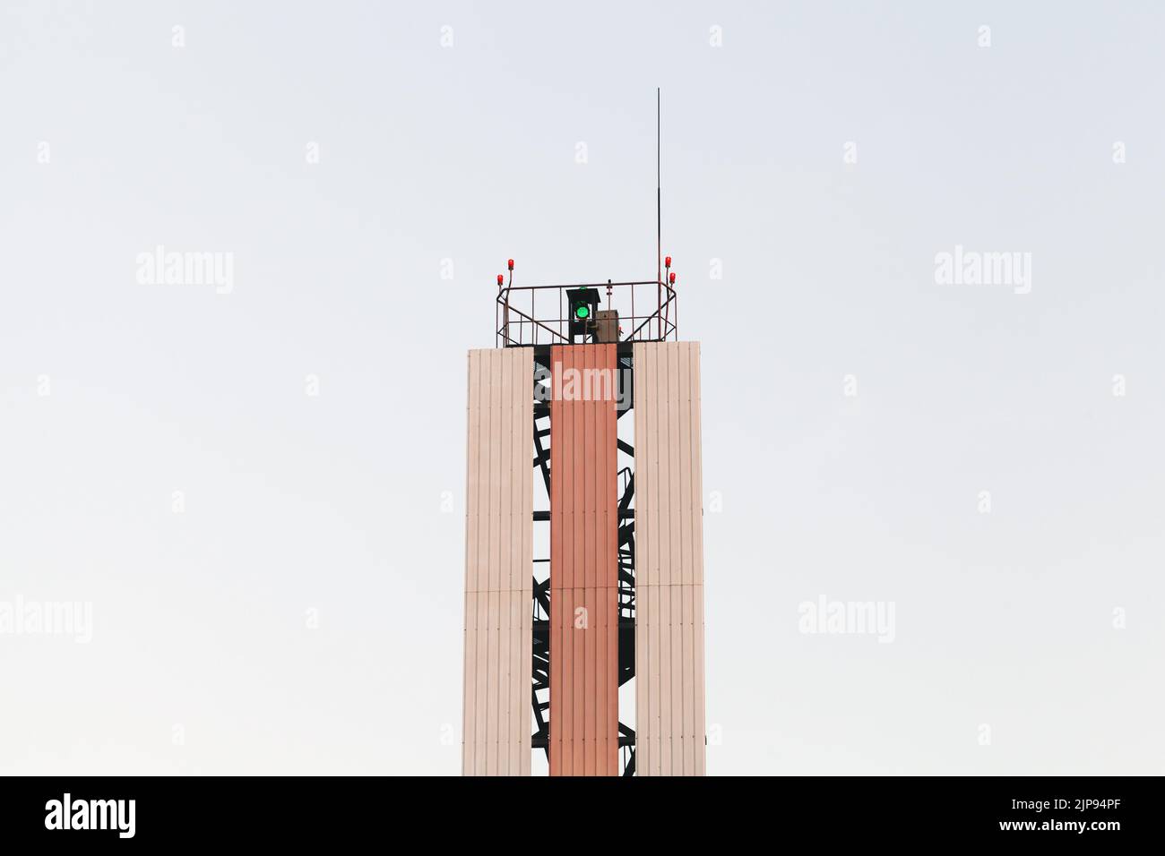 Upper part of a striped leading navigation sign with blue light under ...
