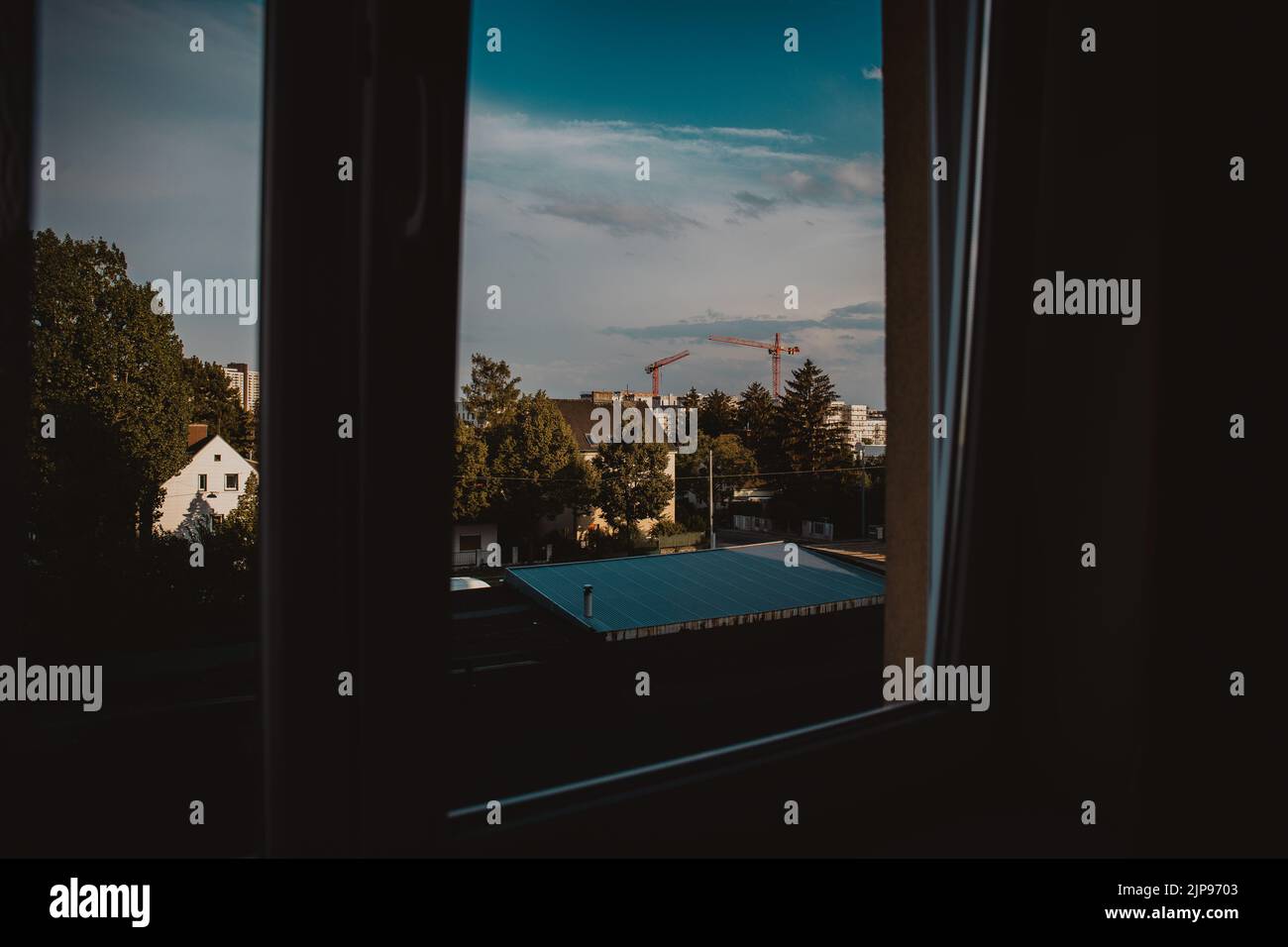 A city view with houses and trees under a blue sky from a window Stock ...