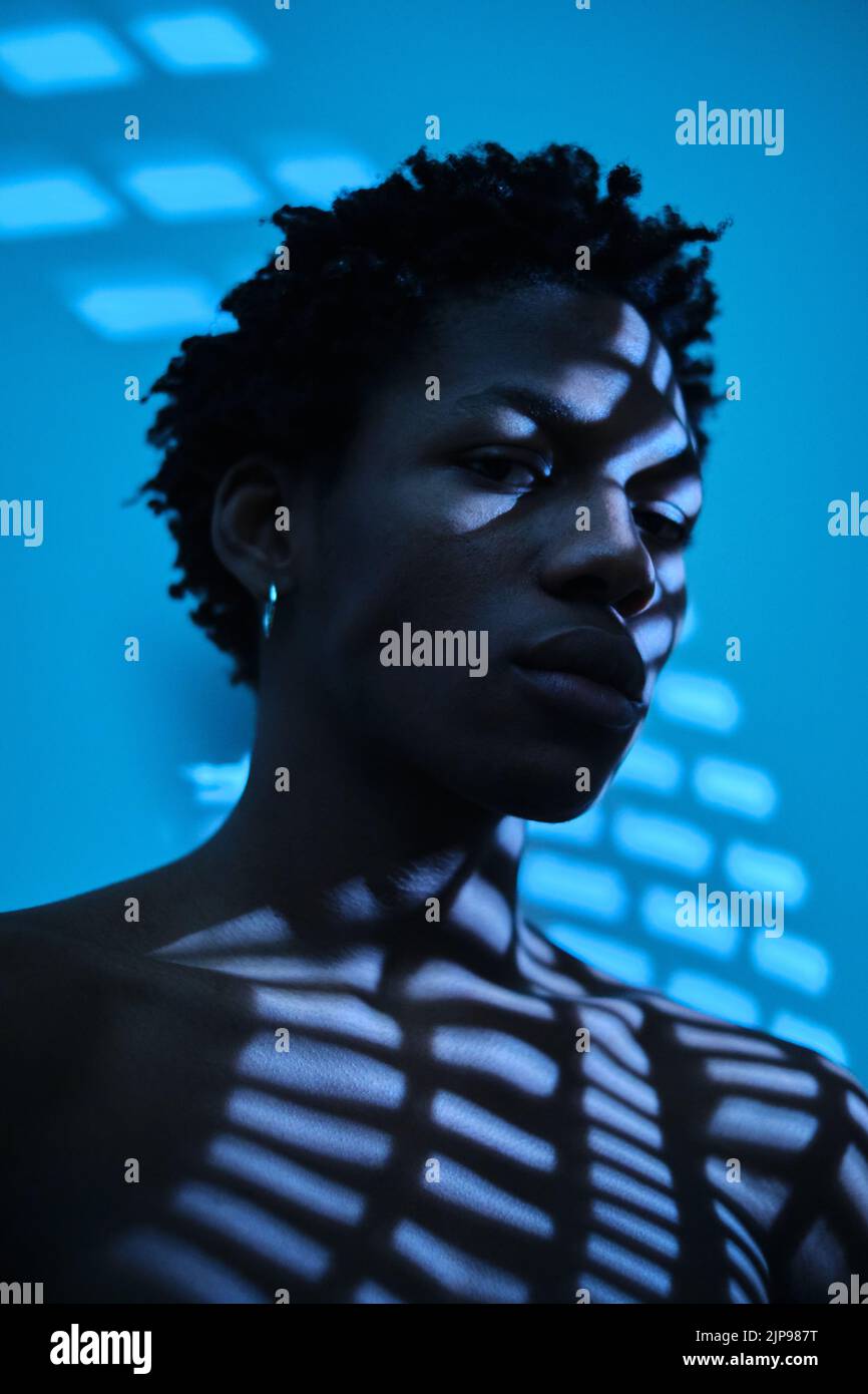 portrait of a young african american man on a blue background with ...
