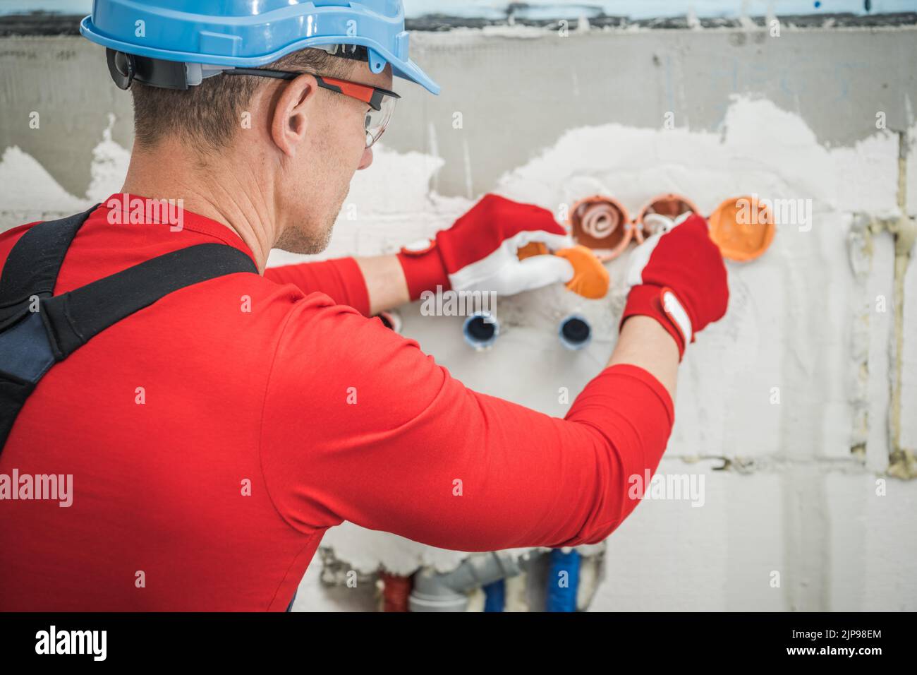 Rear View of Caucasian Electric System Worker Installing Power Plugs in ...