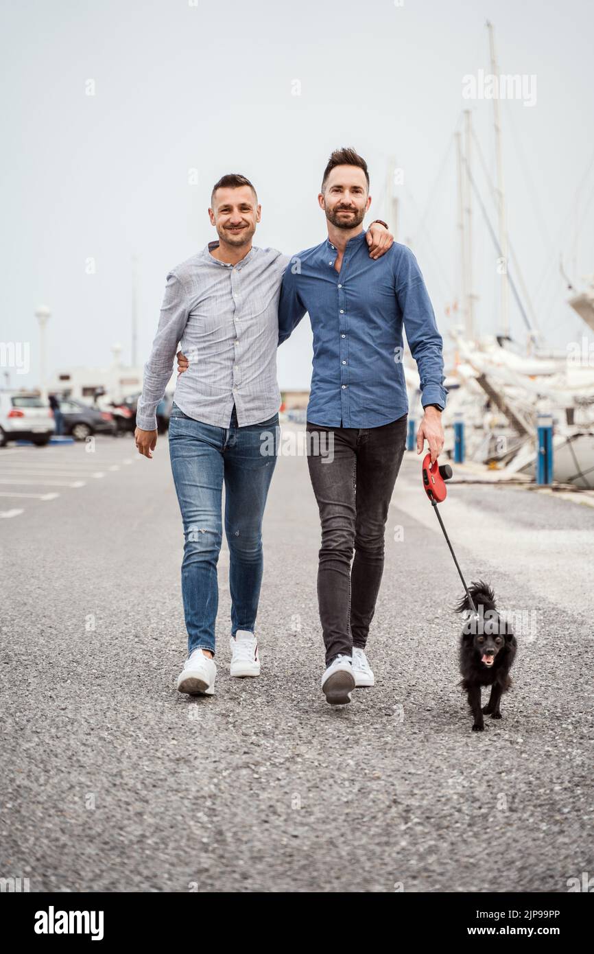 Gay male couple walking dog hi-res stock photography and images - Alamy