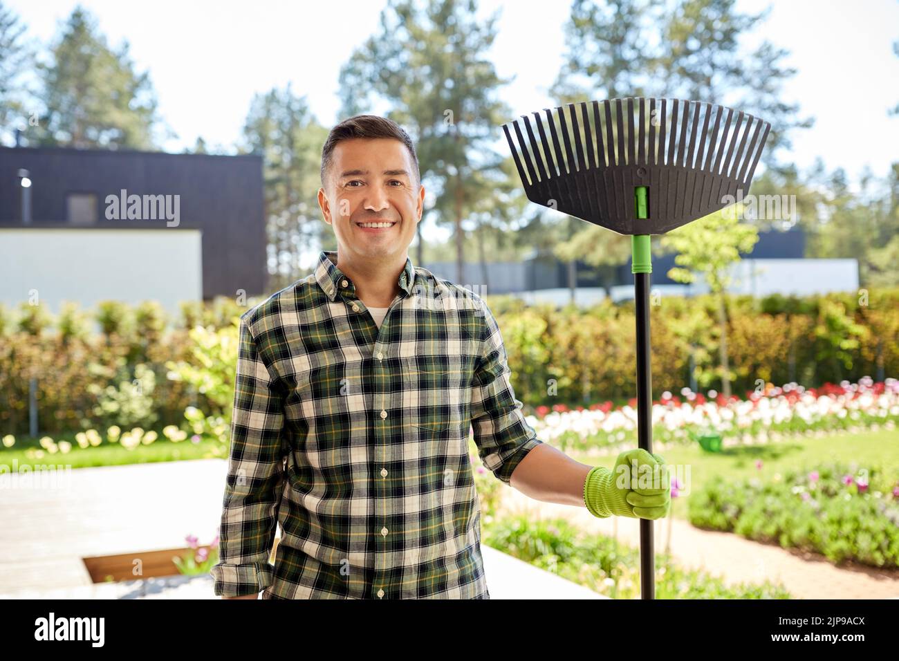 Man with rake hi-res stock photography and images - Alamy