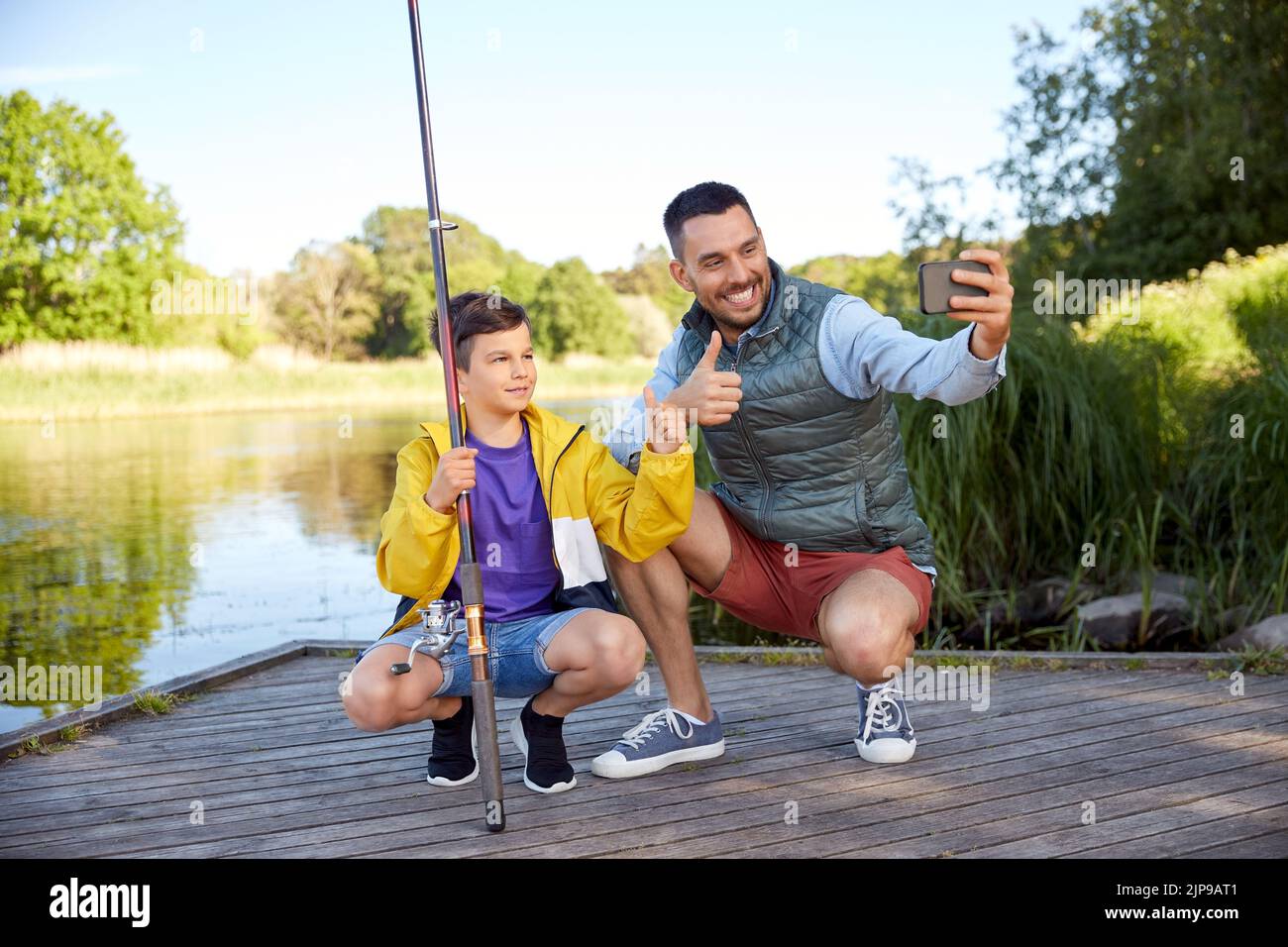 Father photographing son fishing hi-res stock photography and images ...