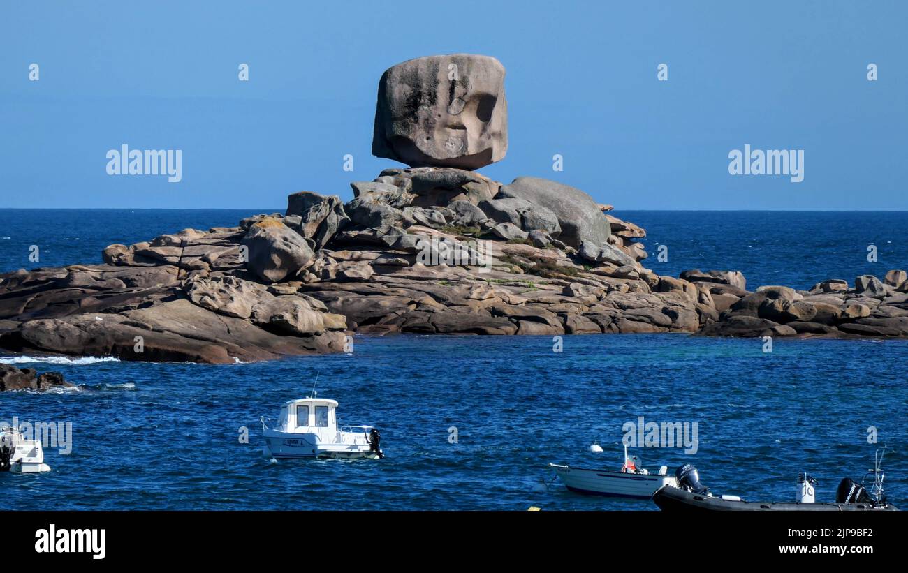 A beautiful view of a huge rock in the sea with boats in France Stock ...