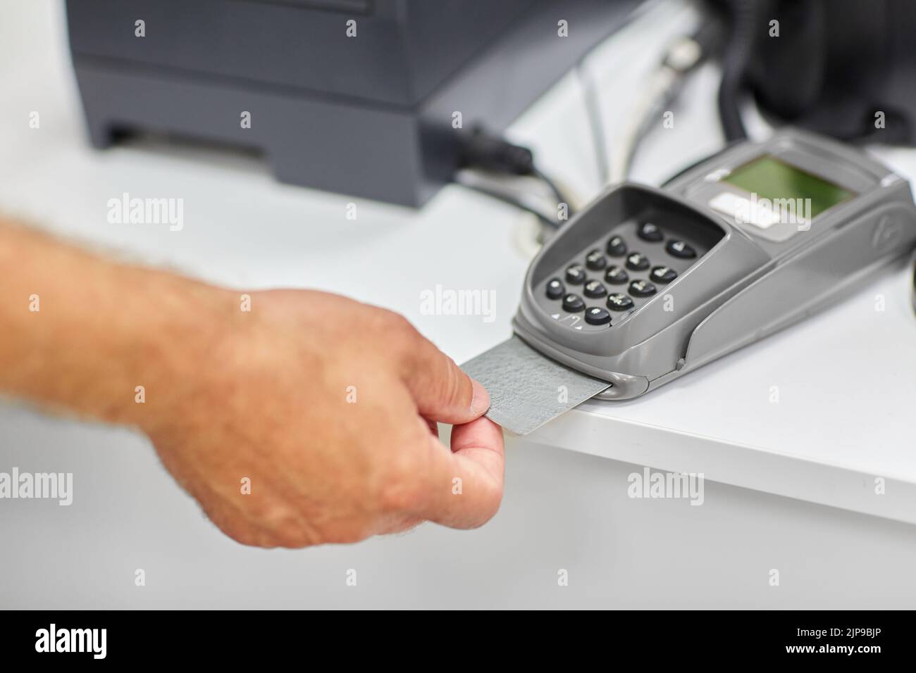 close up of hand with credit card in card-reader Stock Photo - Alamy