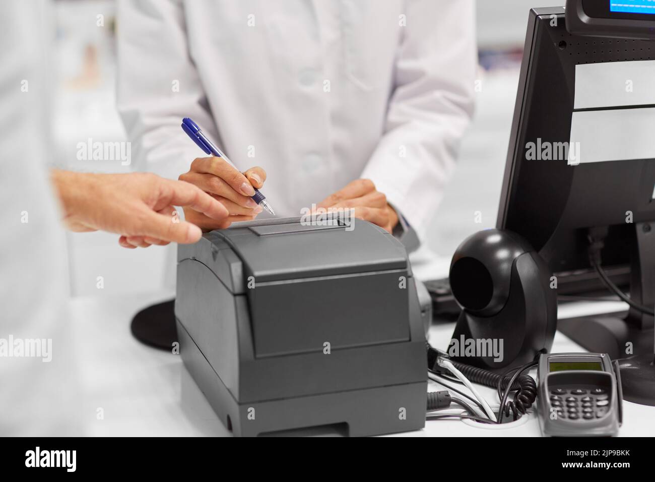 pharmacist and customer at cash register Stock Photo - Alamy