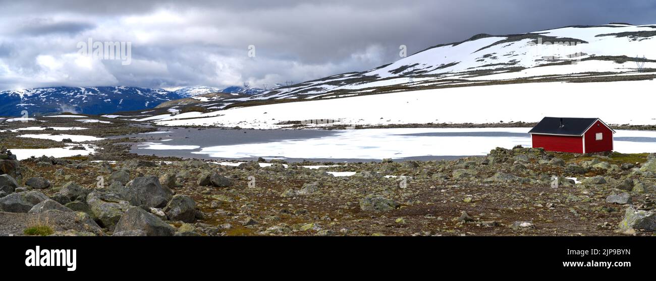 Red house cottage in Norway extra wide panorama on plateau with snow in ...