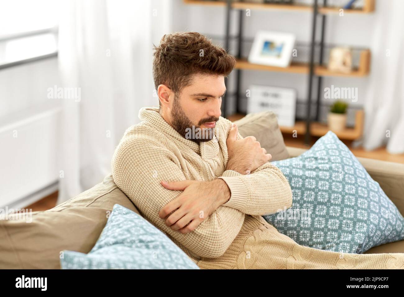 sad sick man in blanket having fever at home Stock Photo - Alamy
