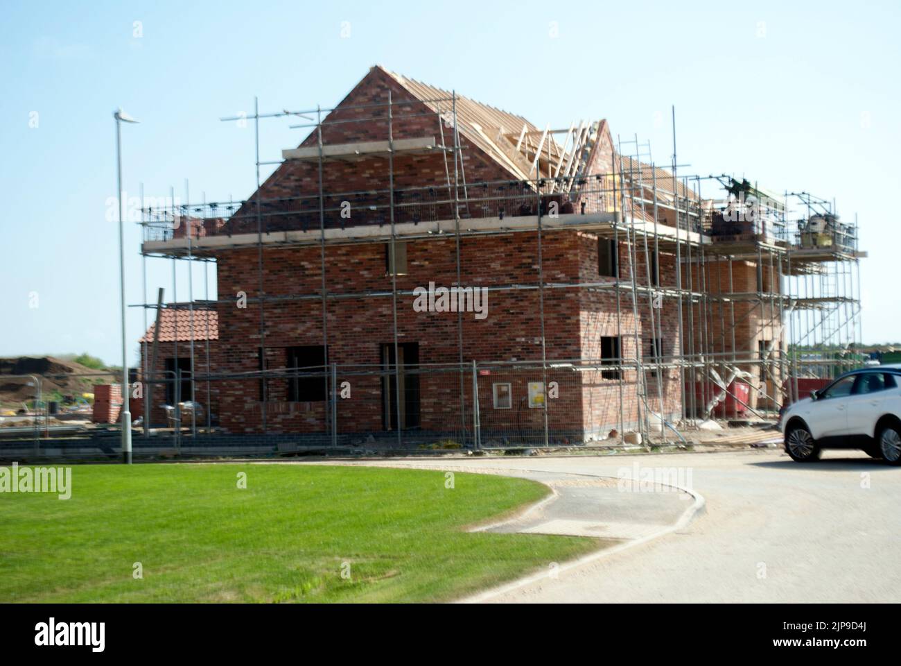 Partially constructed housed surrounded by scaffolding on a building ...