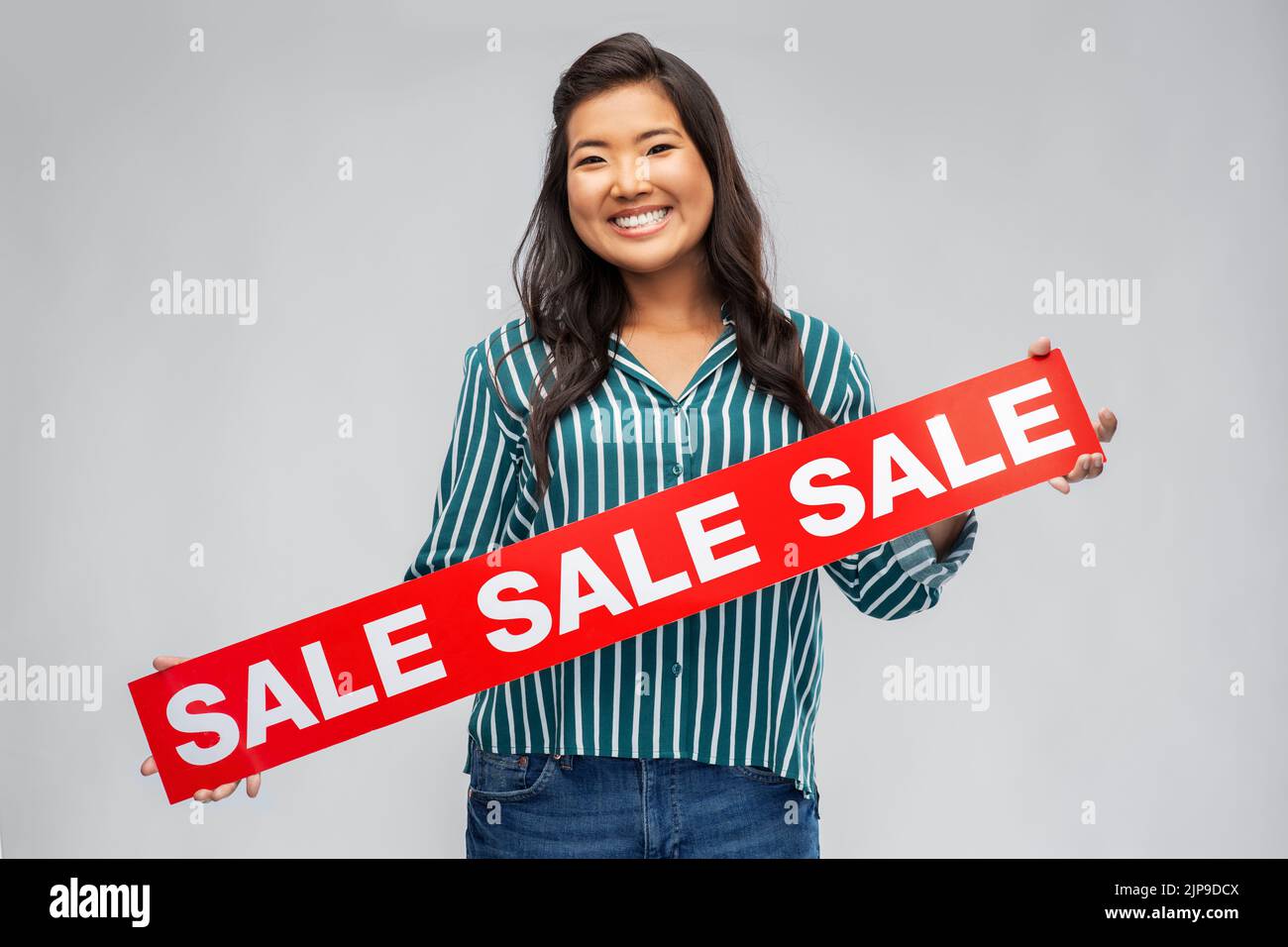 happy smiling young asian woman with sale banner Stock Photo - Alamy