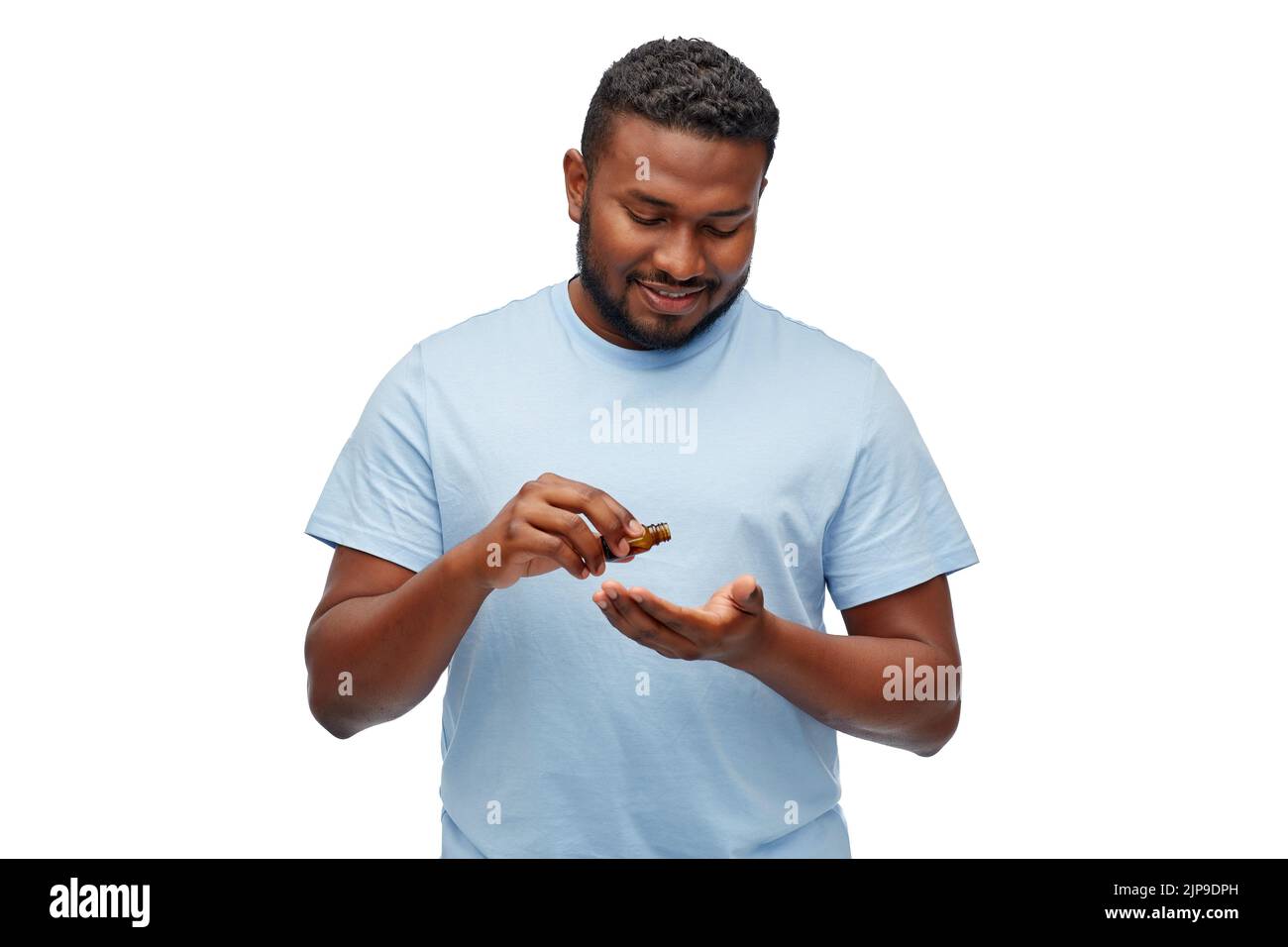 african man applying grooming oil to beard Stock Photo - Alamy