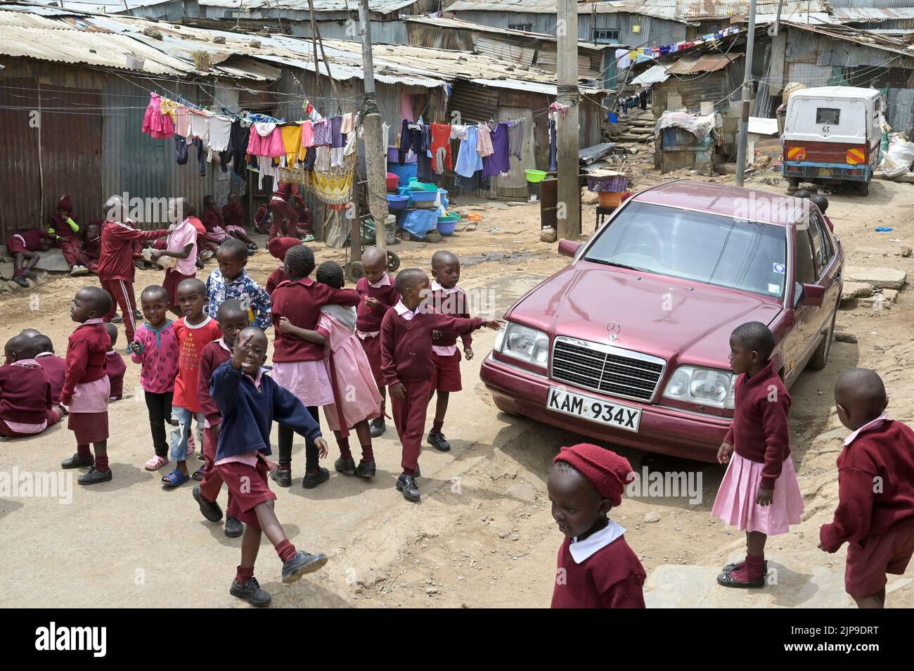 KENYA, Nairobi, Mathare Slum, contrast school children and used ...