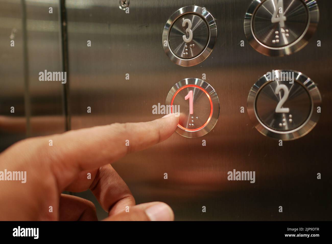 The man push lift button down Stock Photo - Alamy