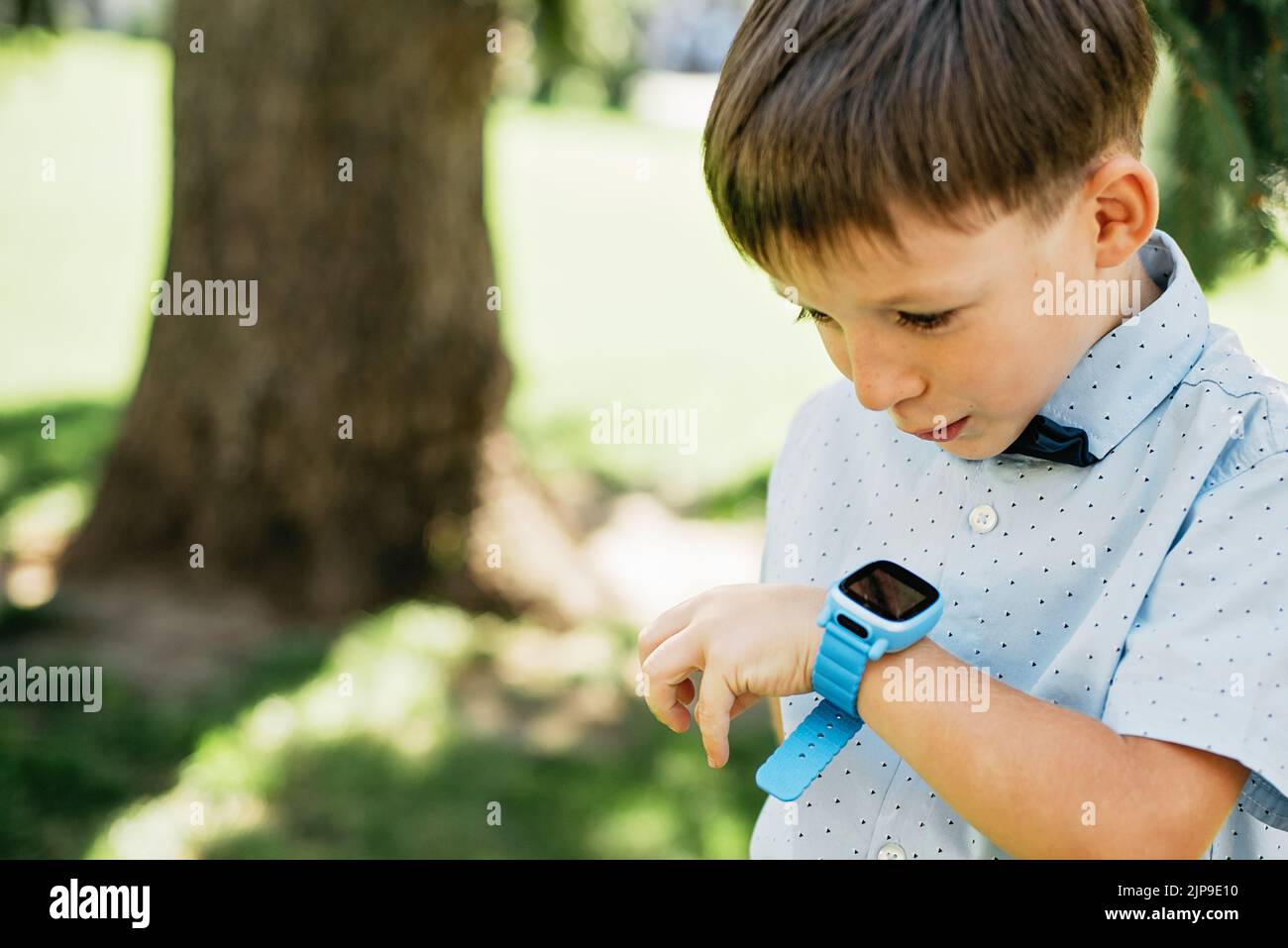 Little boy talking on smart watch with mother. Smartwatch for baby ...