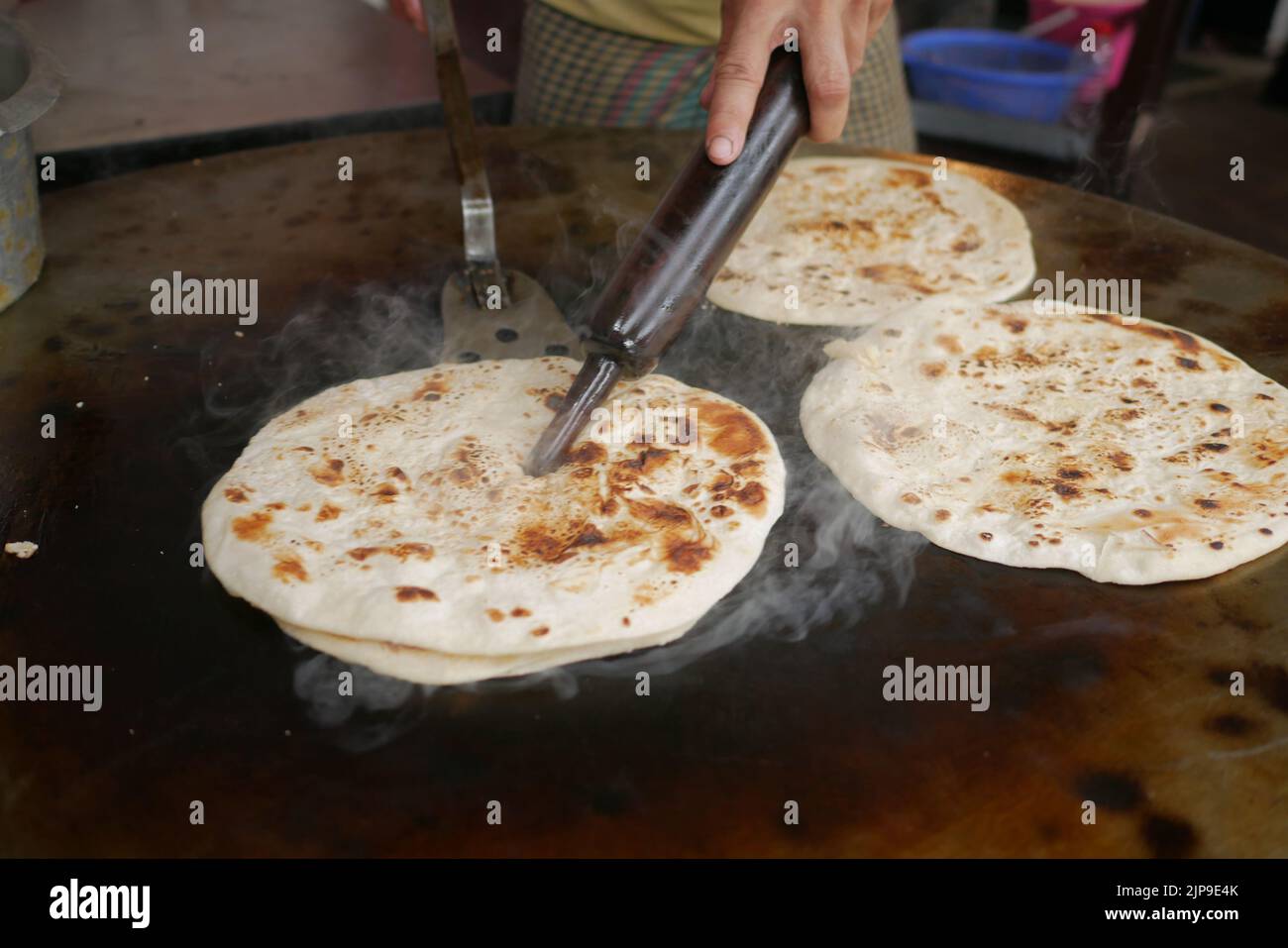 cooking roti chapati on a big cooking pan Stock Photo - Alamy