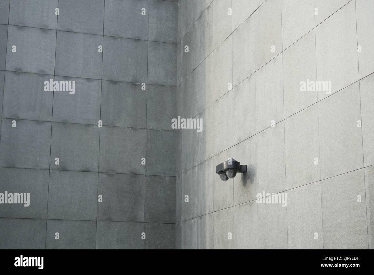 CCTV security camera operating against a wall Stock Photo - Alamy