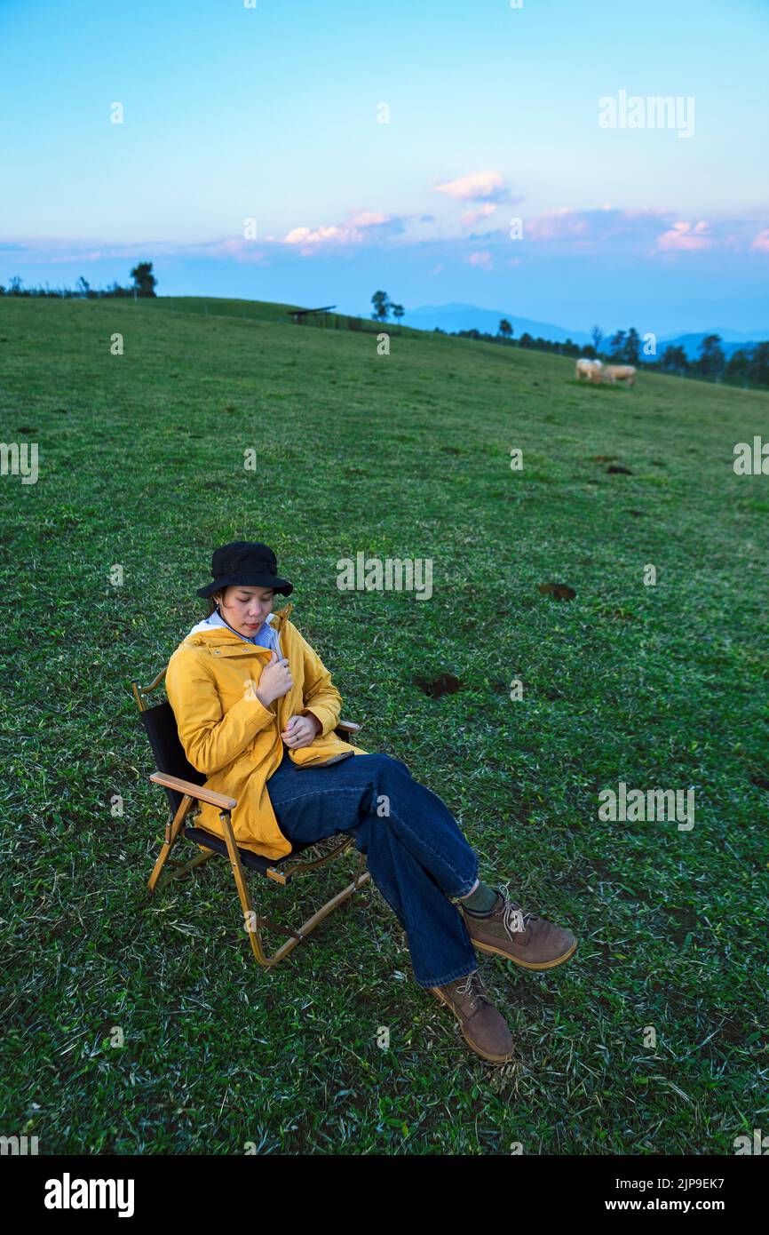 asian female in cowboy fashion style relax her vacation with cows ...