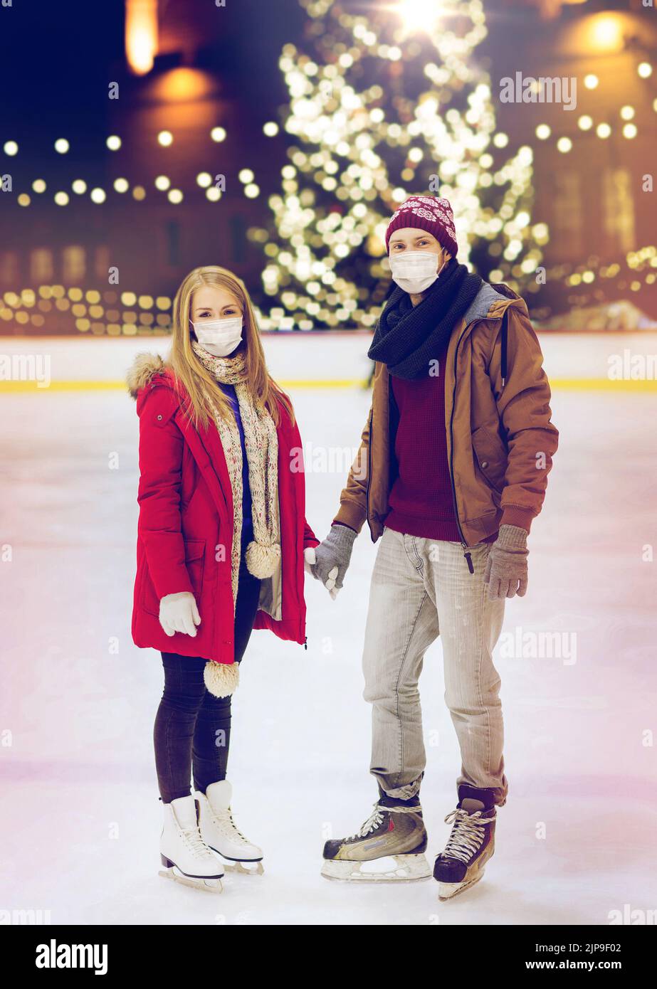 couple in masks holding hands on skating rink Stock Photo - Alamy