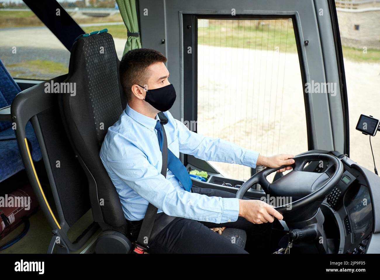 male driver in black mask driving intercity bus Stock Photo - Alamy