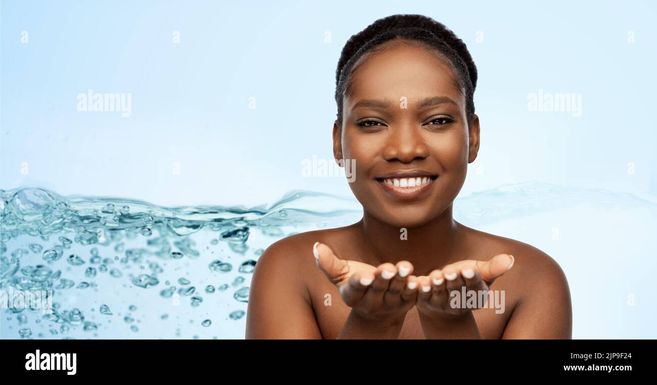 happy african american woman holding something Stock Photo - Alamy