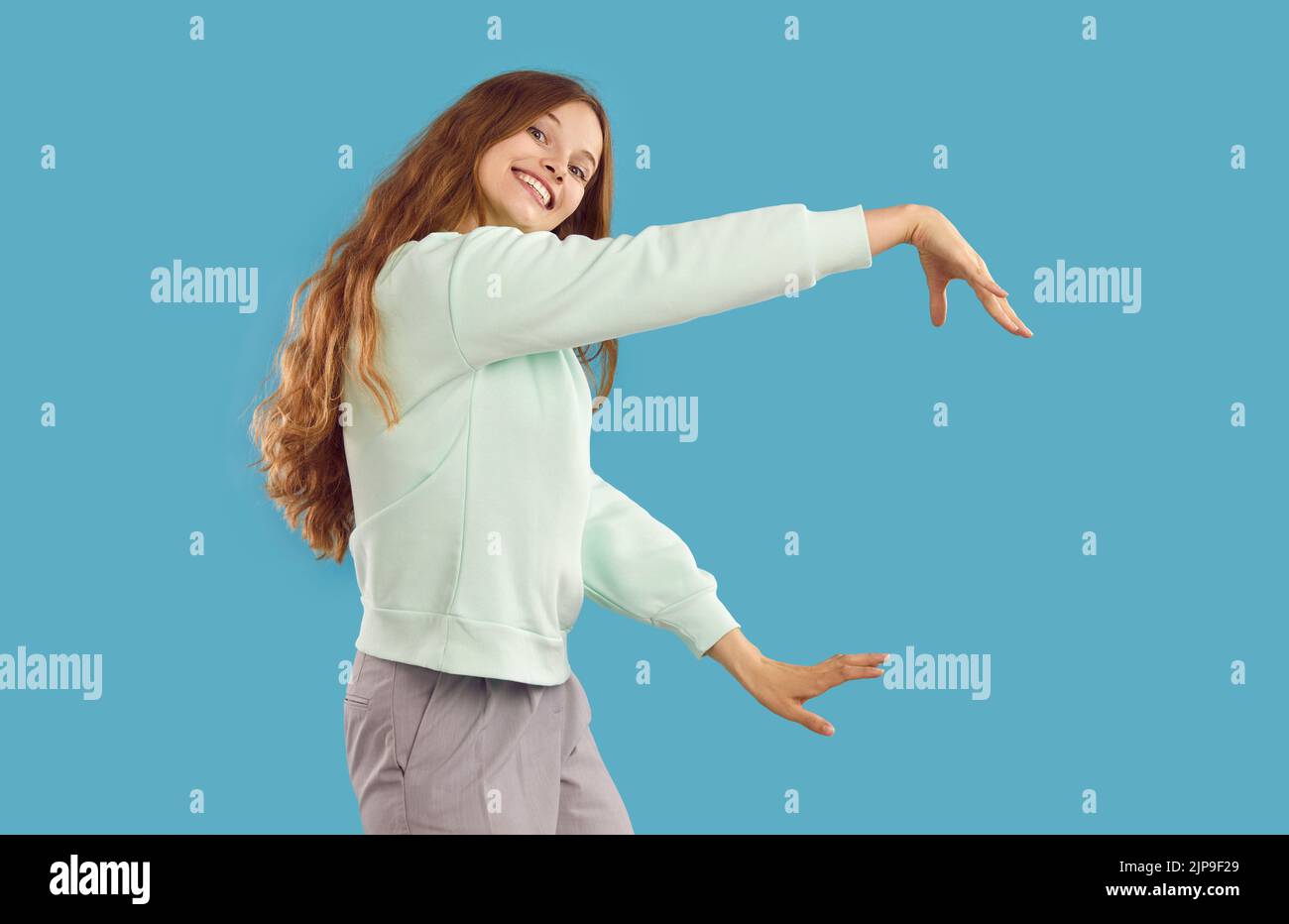 Cheerful carefree young woman listening to music, having fun and ...