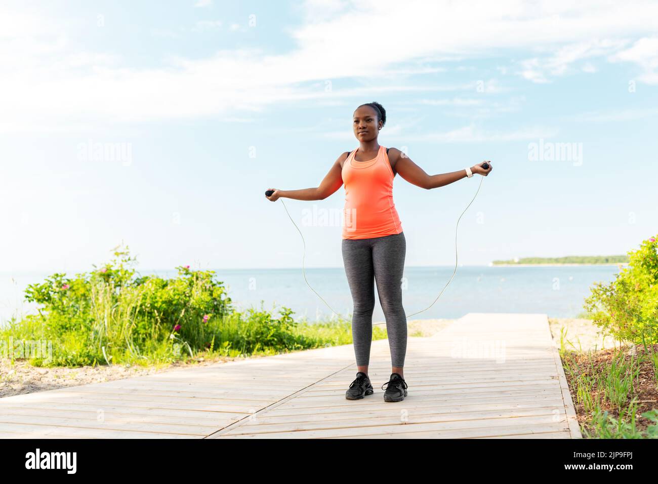 african woman exercising with jump rope on beach Stock Photo - Alamy